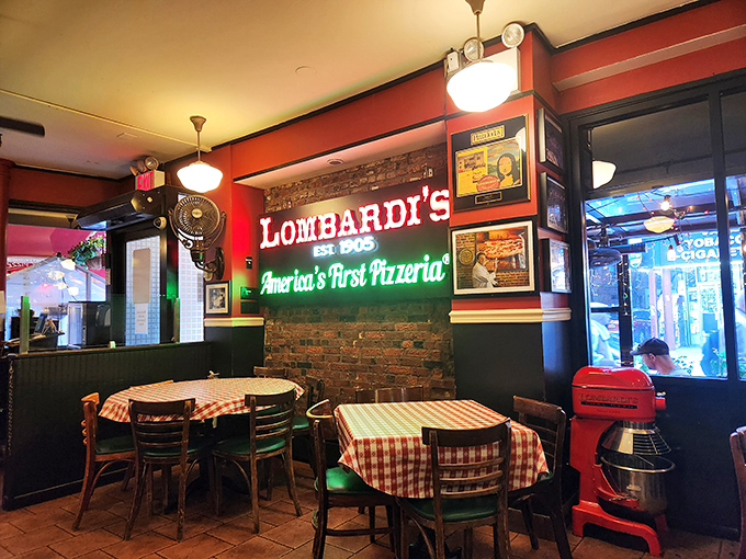 Step inside and the neon glow confirms it: you're standing in pizza holy ground, complete with those nostalgic red-checkered tablecloths.
