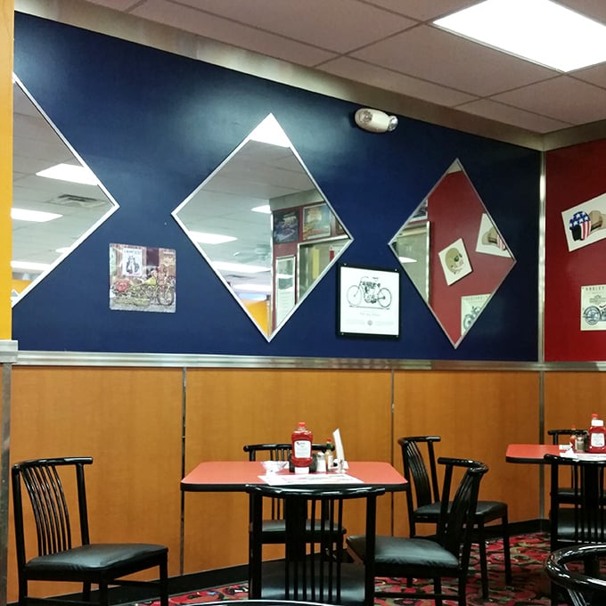 Those diamond-shaped mirrors aren't just for checking if you've got syrup on your chin&mdash;they're part of the diner's distinctive blue and red decor that screams "authentic Americana."