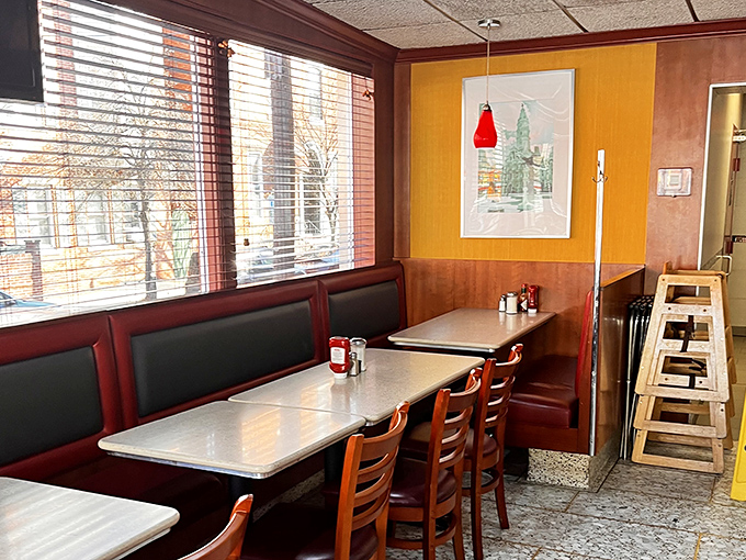 Red vinyl booths and wood paneling – the diner equivalent of a warm hug. This corner spot practically whispers "slide in and stay awhile."