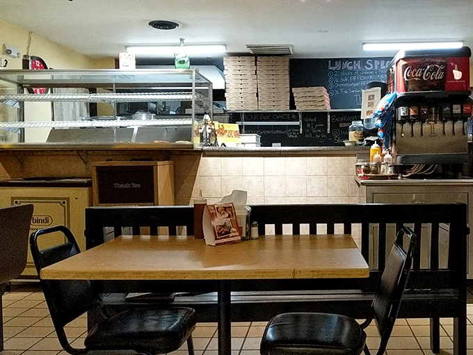 No-frills counter service where pizza dreams begin. The stacks of boxes stand ready for the dinner rush that locals know all too well.