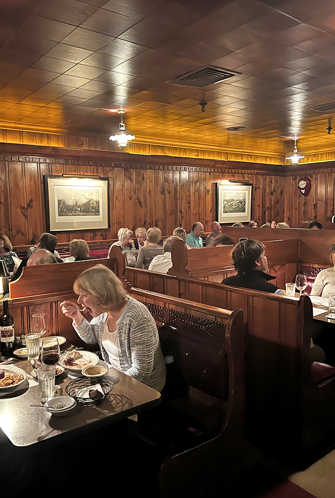 Wood-paneled walls and high-backed booths create that perfect old-school steakhouse ambiance where conversations flow as smoothly as the wine.