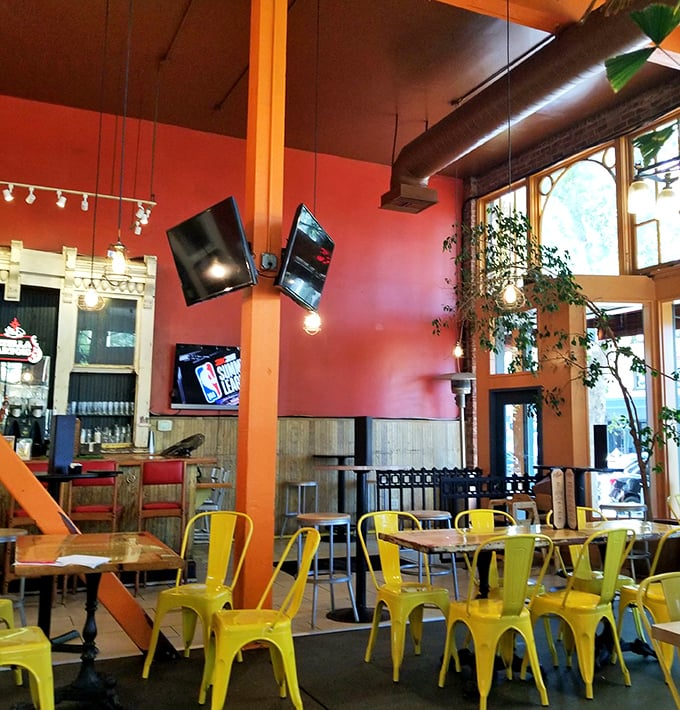 Bright yellow chairs pop against warm red walls, creating a space that's both energizing and cozy &ndash; the perfect backdrop for serious meat consumption.