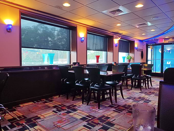 Blue accent lighting transforms this dining area into something special, where comfort meets class without any unnecessary fuss.