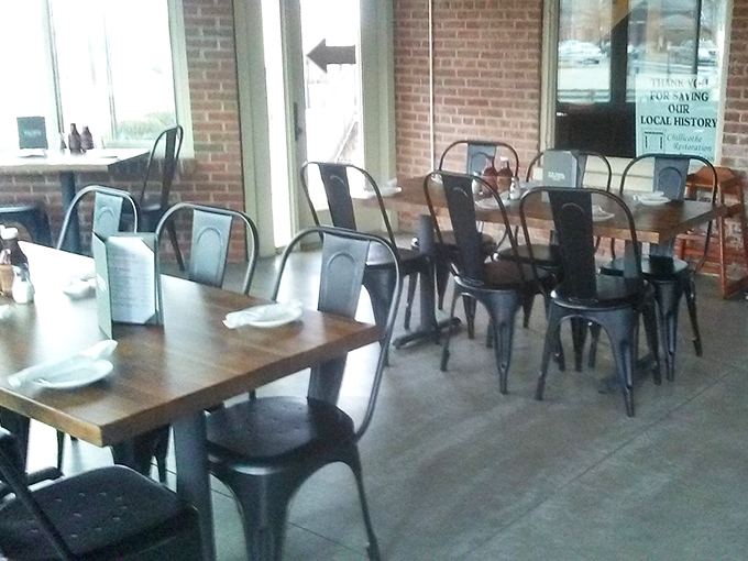 Industrial-chic meets comfort in this dining space where metal chairs and wooden tables create the perfect backdrop for smoky masterpieces.
