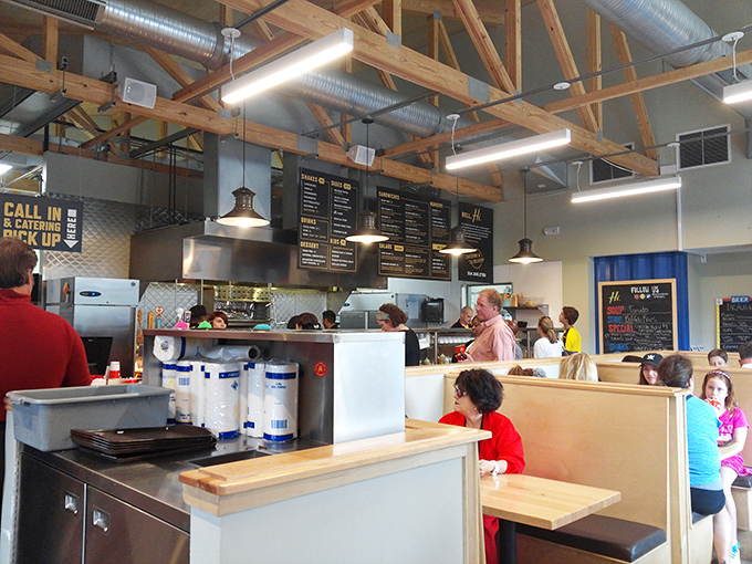 Industrial chic meets comfort food haven inside, where wooden beams and open kitchen transparency let you witness the sandwich magic before it hits your plate.