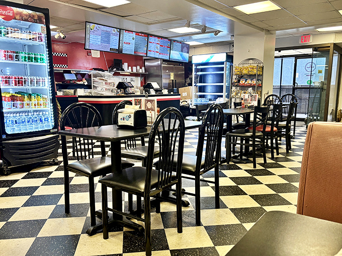 The classic black and white checkered floor says "we've been doing this awhile," while those red chairs whisper "stay a little longer."