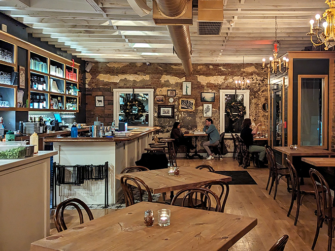 Exposed brick walls tell stories while vintage chandeliers cast the kind of warm glow that makes everyone look like they're in a Scorsese film about really good pizza.