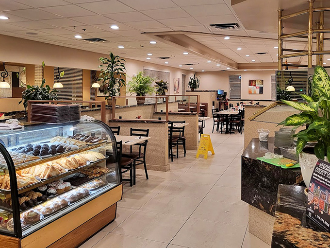 Inside, the spacious interior balances modern comfort with nostalgic charm. Plants add life while the pastry case whispers sweet temptations to willpower-challenged patrons.