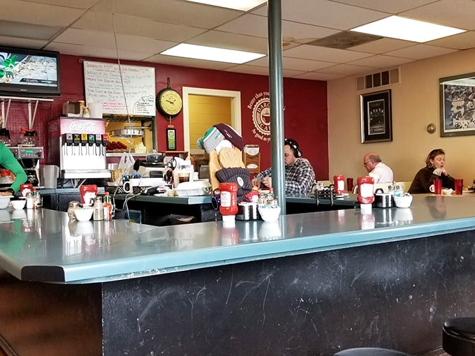 The counter at Darcy's is where breakfast magic happens &ndash; red walls, blue-rimmed countertop, and the symphony of sizzling griddles create the perfect diner atmosphere.