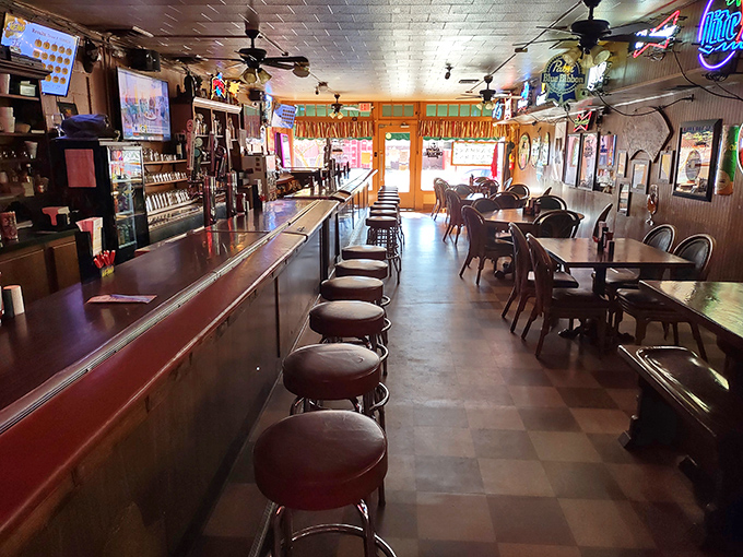 Inside, the classic checkered floor and well-worn bar stools tell stories of countless meals shared, beers clinked, and friendships forged.
