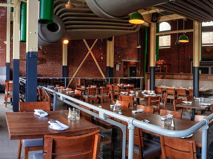 Industrial chic meets comfort in this thoughtfully preserved space where exposed pipes and brick walls tell stories while wooden tables invite intimate conversations.
