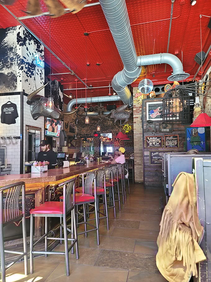 Industrial chic meets meat-lover's fantasy under that striking red ceiling. The disco ball suggests your taste buds might just dance with joy.