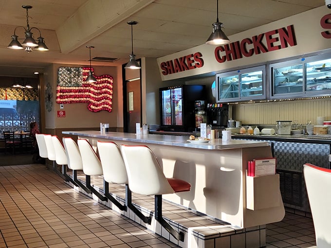 Classic Americana at its finest&mdash;white counter stools, patriotic decor, and a counter that's witnessed countless coffee refills and local gossip sessions.