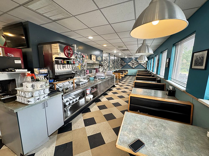 Classic diner aesthetics meet hometown comfort inside, where the checkered floor and teal walls create the perfect backdrop for memorable meals.