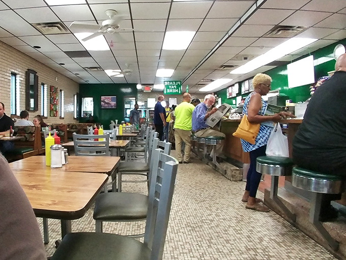 Classic diner vibes with green walls and counter seating where sandwich dreams become delicious, messy reality.
