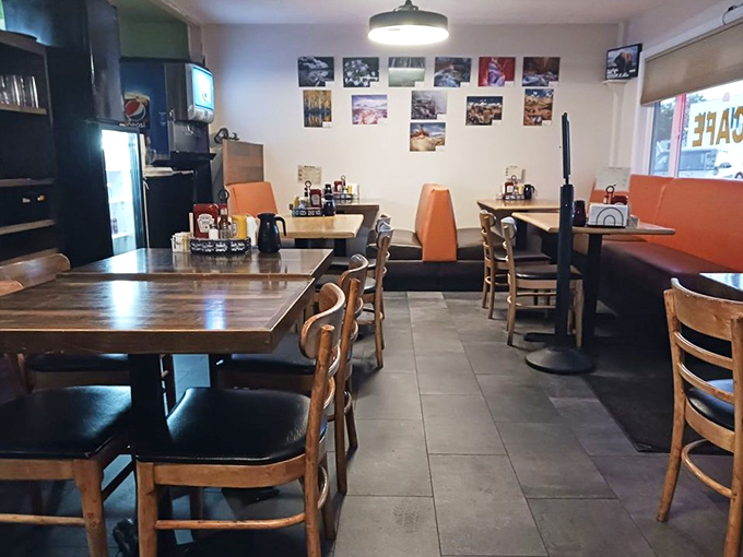 Simple wooden tables and orange booths create that perfect "everybody knows your name" atmosphere where comfort trumps pretension every time.