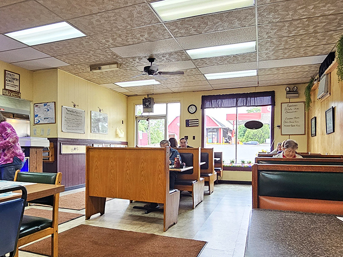 Classic diner booths and wood paneling create that "everybody knows your name" atmosphere where conversations flow as freely as the coffee refills.