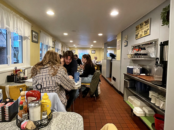The quintessential diner experience &ndash; narrow, efficient, and buzzing with conversation. Every booth holds stories and every counter seat promises satisfaction.