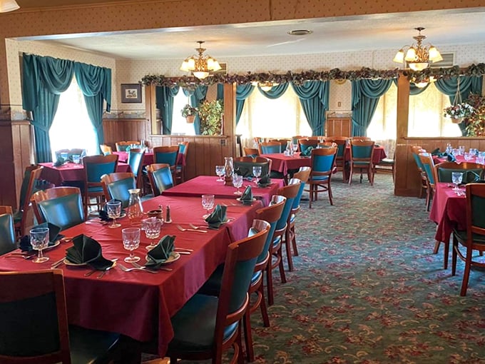 Classic elegance meets Midwestern warmth where burgundy linens and teal drapery create timeless dining ambiance.