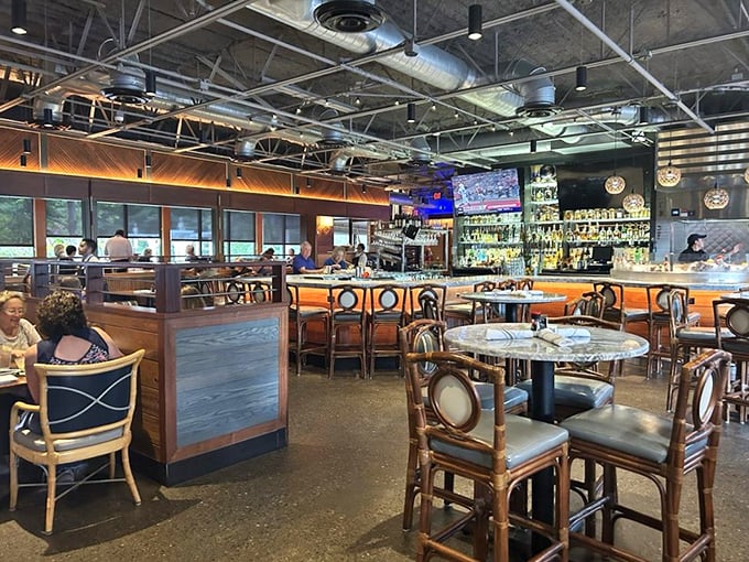 Industrial chic meets coastal comfort in this thoughtfully designed dining room. Those bamboo chairs aren't just stylish&mdash;they're telling you to stay awhile.