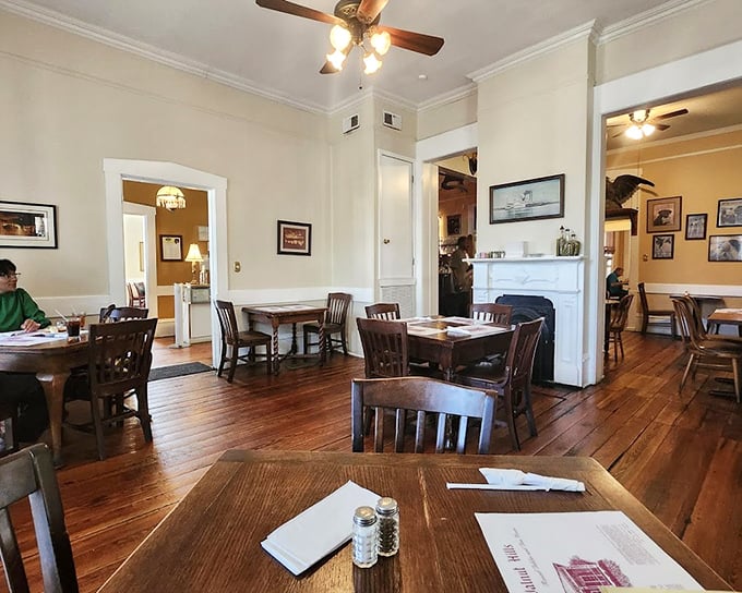 Polished hardwood floors and white walls create the perfect canvas for what matters most here—the food and the fellowship that happens around these tables.