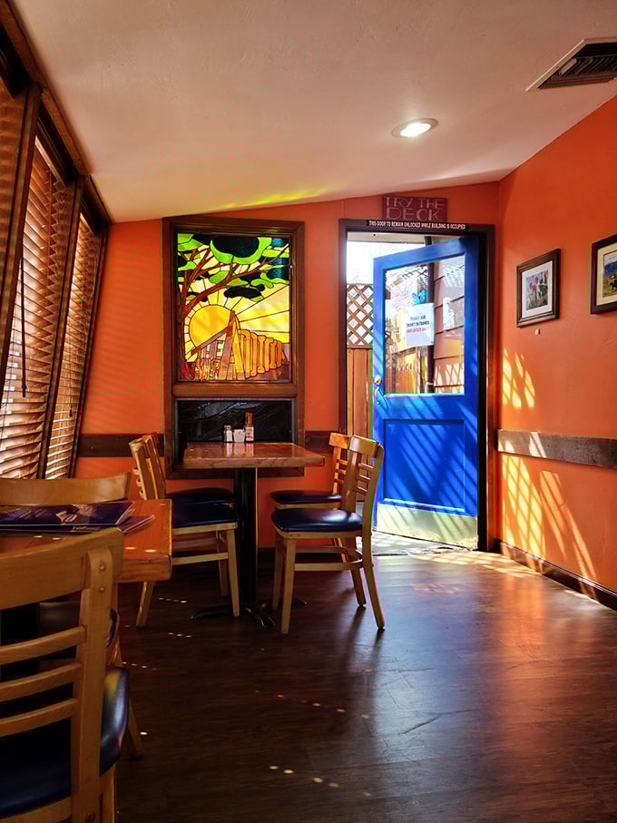 Sunlight dances through a stunning stained glass window, painting the terracotta walls with warmth that makes even first-time visitors feel like regulars.