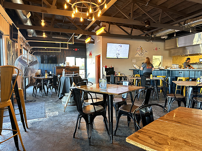 Industrial-chic meets comfort in Boonedogs' interior, where wooden tables, metal chairs, and those magical string lights create the perfect backdrop for serious food appreciation.
