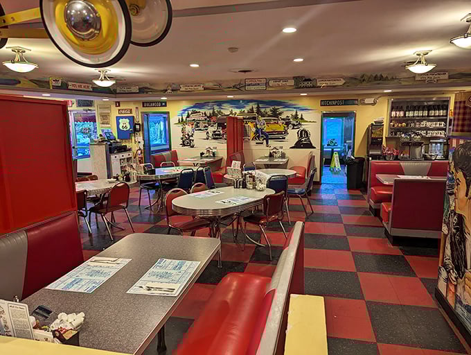 Checkerboard floors and vinyl booths set the stage for culinary nostalgia. The mural whispers stories of road trips past while promising delicious journeys ahead.