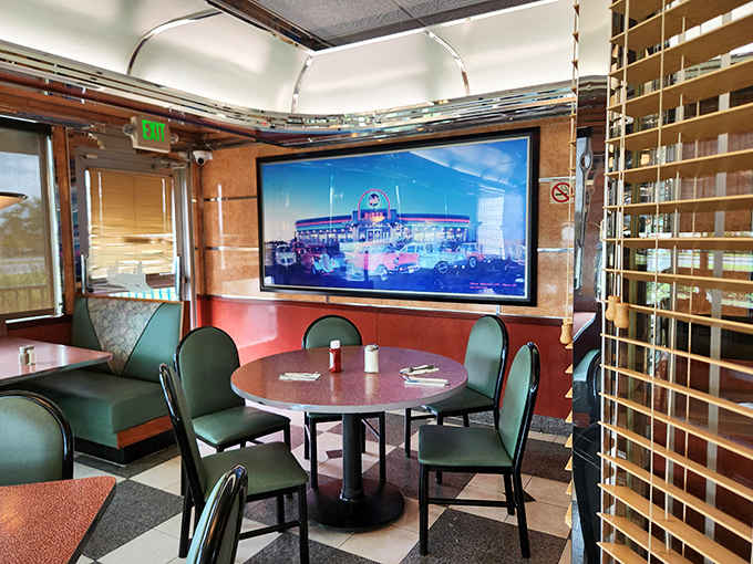 Inside, classic diner booths upholstered in that unmistakable green vinyl create the perfect setting for conversations that flow as freely as the coffee.