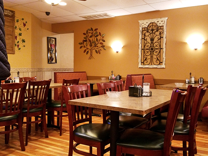 Warm yellow walls, wooden accents, and comfortable seating create that rare dining atmosphere where you instantly feel like a regular, even on your first visit.