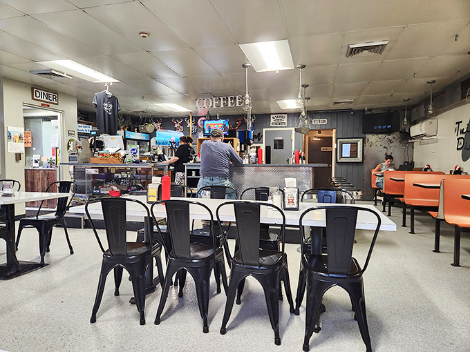Step inside and time slows down &ndash; black metal chairs, orange booths, and that unmistakable "COFFEE" sign promising the fuel for conversations yet to come.