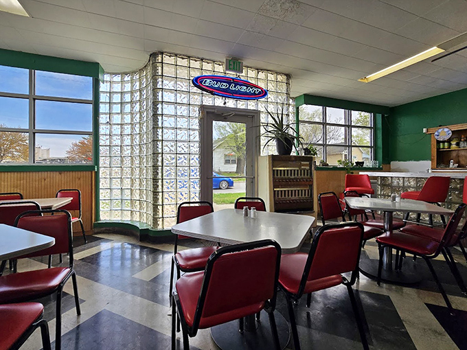 Glass blocks and red vinyl chairs create the perfect backdrop for culinary nostalgia. This isn't retro by design—it's authentic by survival.