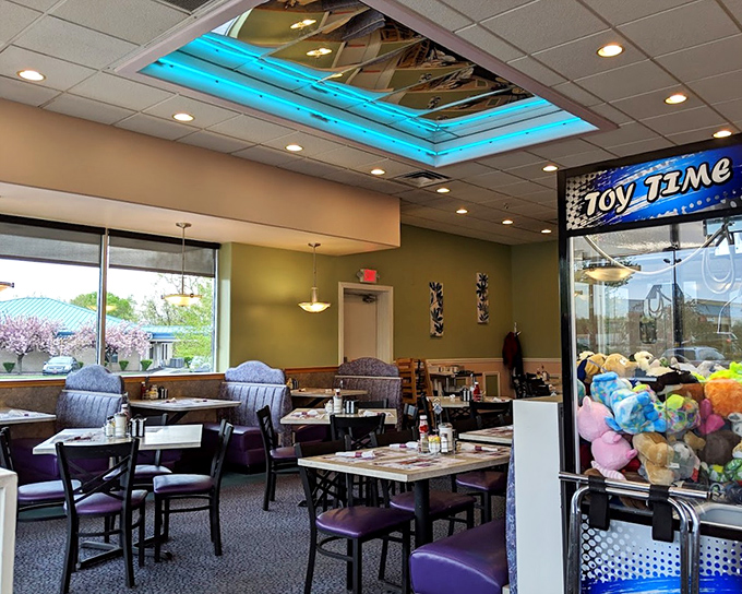 That blue-lit skylight isn't just for show&mdash;it's nature's way of saying "these eggs deserve dramatic lighting." Purple booths add a royal touch to your dining experience.