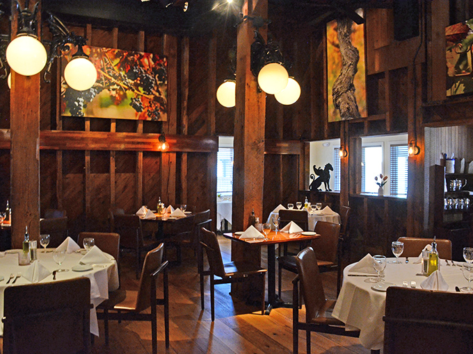 Exposed beams, globe lights, and white tablecloths create that perfect "special occasion that feels like home" atmosphere we're all searching for.