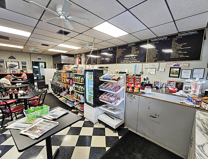 Classic black and white tiles that have witnessed countless breakfast debates. This isn't interior design &ndash; it's a time machine to when delis were the heart of neighborhoods.