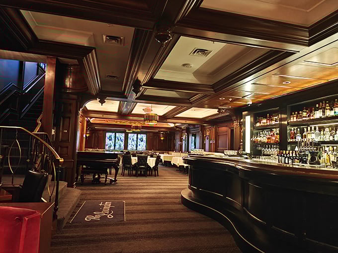 Rich wood paneling and a curved bar create the perfect backdrop for both celebration and quiet conversation.
