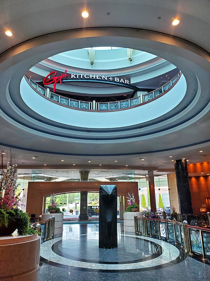 Guy Fieri's Kitchen + Bar sits beneath a soaring architectural dome, proving that both your appetite and shopping bags can reach impressive heights here.