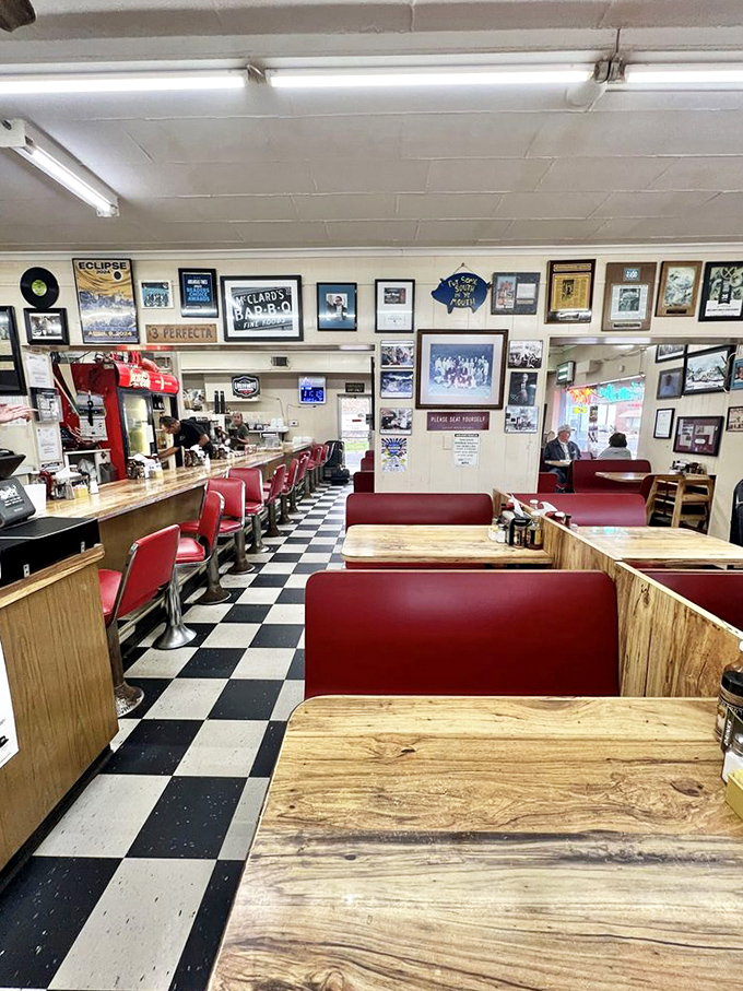 Classic red vinyl booths, checkered floors, and walls filled with memories&mdash;this isn't interior design, it's BBQ history in physical form.