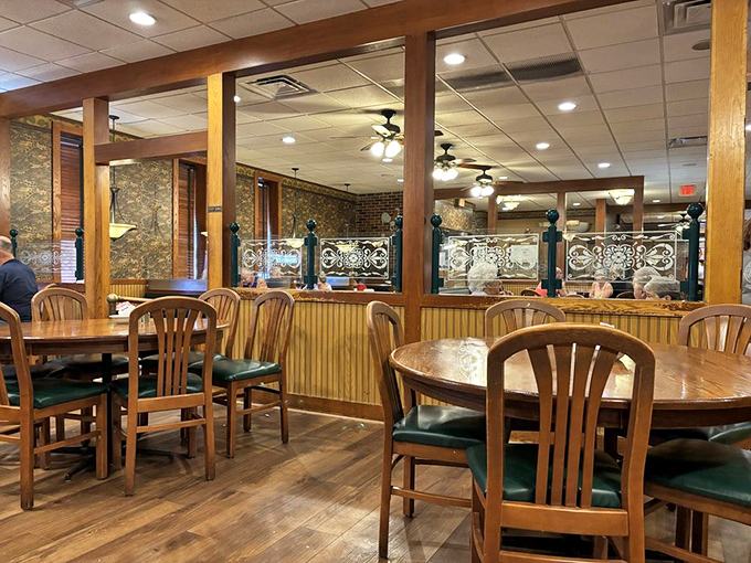 Wooden booths and chairs with green cushions create that perfect diner atmosphere&mdash;where conversations flow as freely as the coffee.
