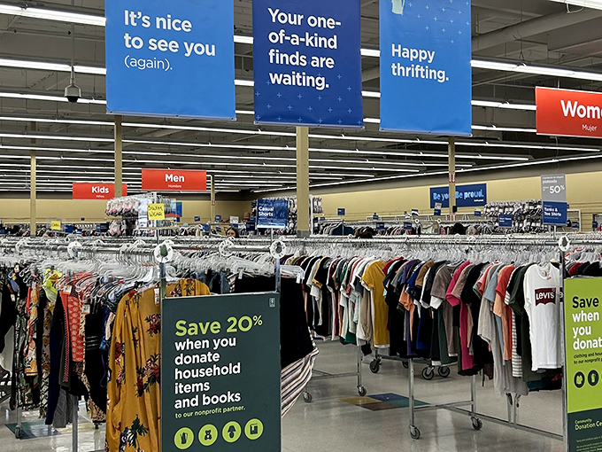 Blue banners hang like friendly signposts, guiding you through a sea of carefully organized clothing racks that stretch toward retail infinity.