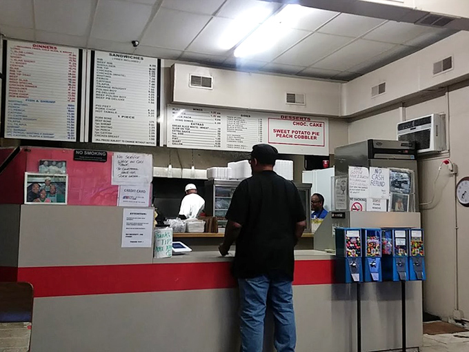 The no-frills ordering counter where barbecue dreams begin. Notice the sweet potato pie and peach cobbler signs &ndash; they're not afterthoughts.