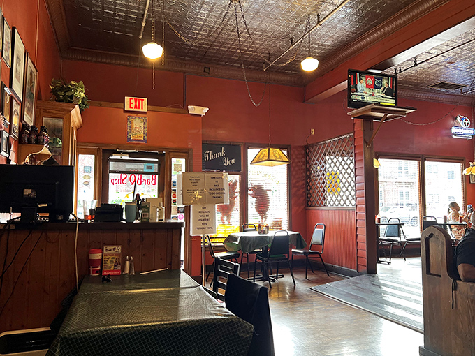 Step inside and the warm red walls embrace you like a hug from your favorite barbecue-scented aunt. This is comfort defined.