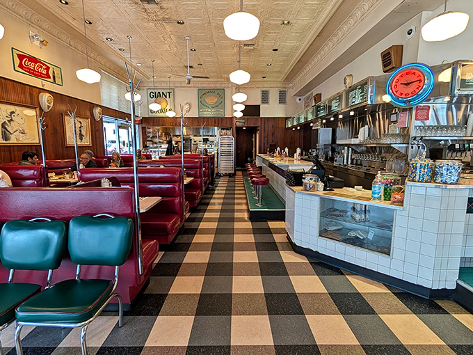 Step inside where red vinyl booths and checkered floors create the perfect stage for culinary nostalgia.