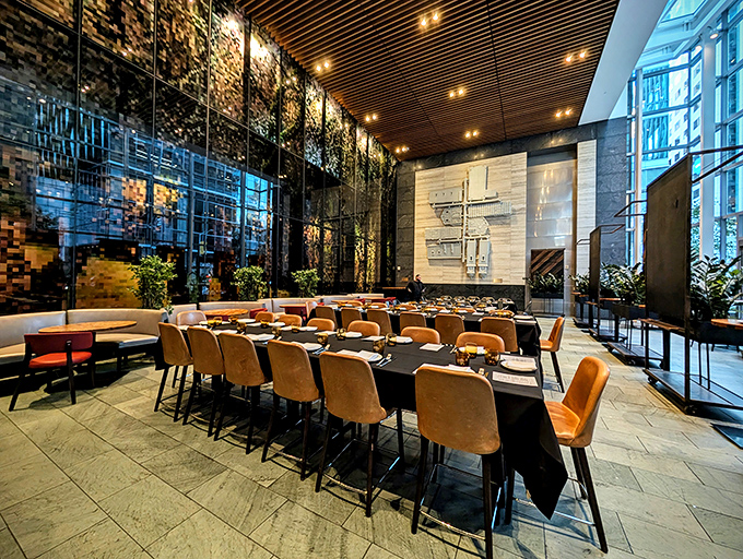 Soaring ceilings, warm wood tones, and sleek design create a dining room that's both impressive and inviting&mdash;California cool meets global warmth.