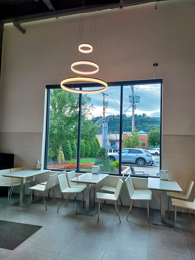 Modern meets cozy in this bright seating area where ring-shaped lights dangle like halos above tables where pastry dreams come true.