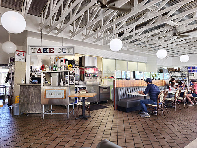 Inside, globe lights hang from exposed white beams, creating that perfect diner atmosphere where good mornings are practically guaranteed.