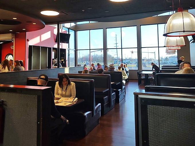 Modern meets cozy in this dining room where natural light floods through floor-to-ceiling windows. The kind of place where conversations flow as smoothly as the service.