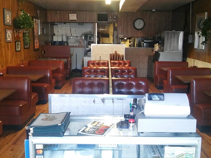 Red vinyl booths and wood paneling create the kind of timeless diner atmosphere that fancy restaurants spend millions trying to fake.