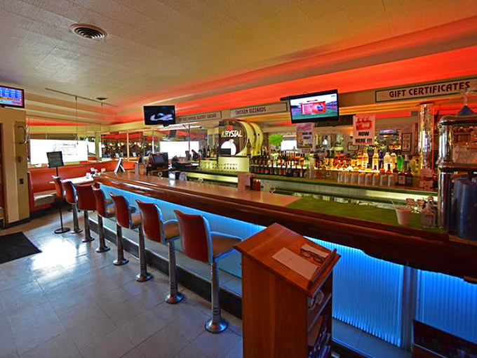 The classic bar gleams with decades of stories, where red neon casts a warm glow and every barstool has probably heard it all.