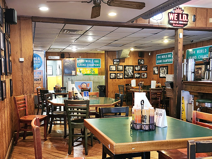 Wood-paneled walls adorned with championship banners tell the story before you even taste a bite. This is serious barbecue territory.